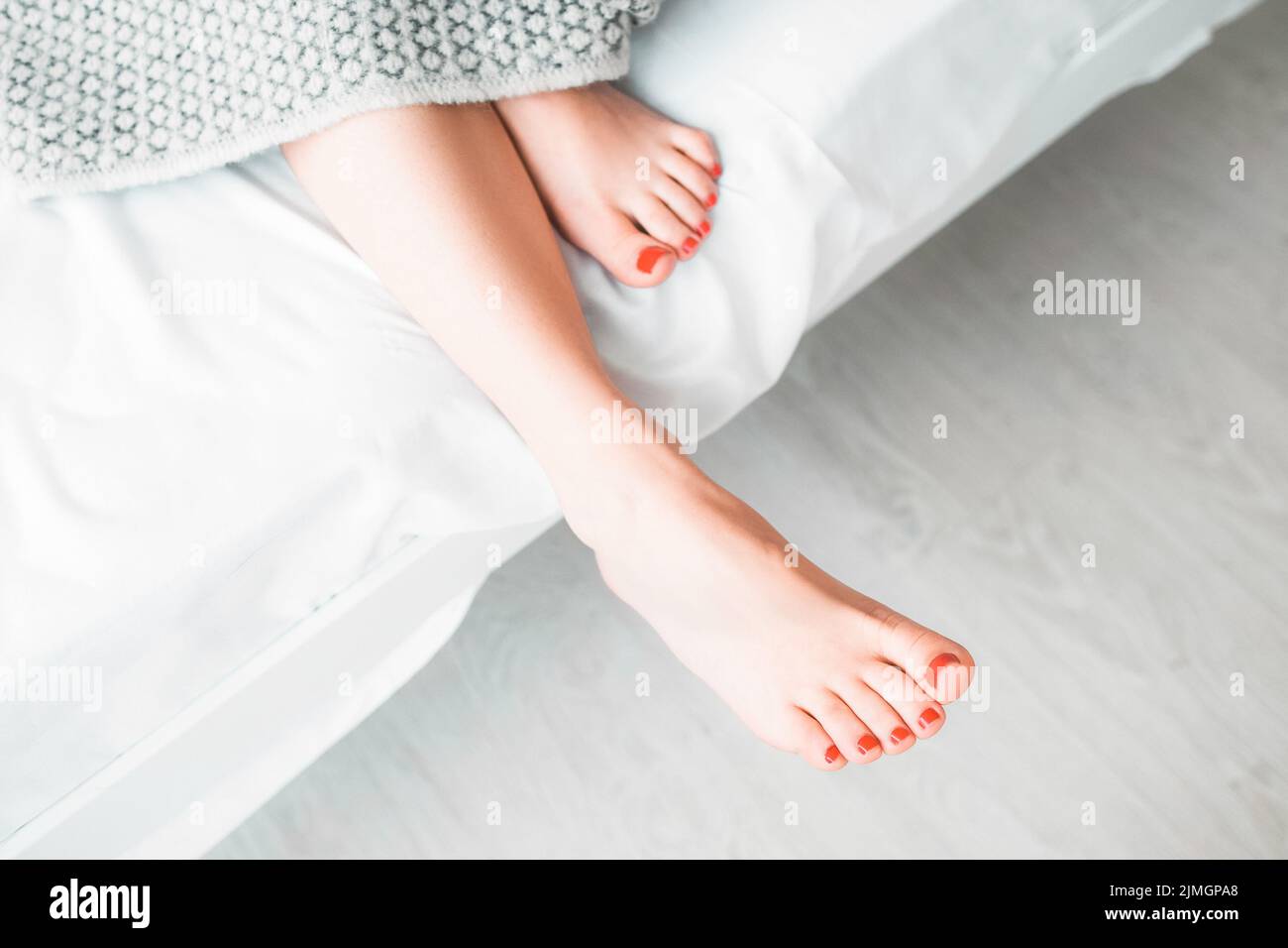 body care wellness barefoot woman legs bed Stock Photo - Alamy
