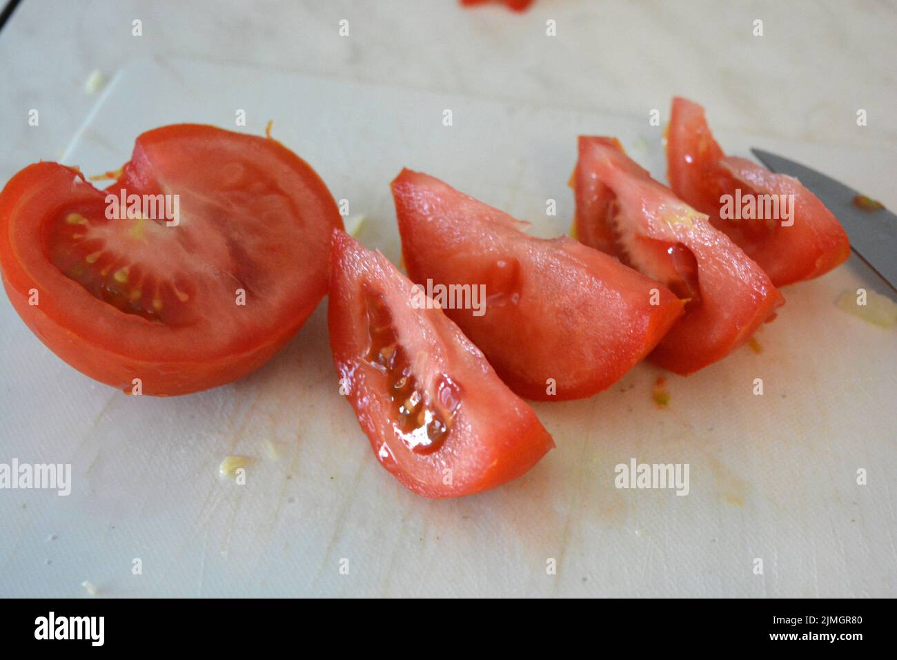 Healthy food, vegetables, large red tomatoes cut into slices or covered ...
