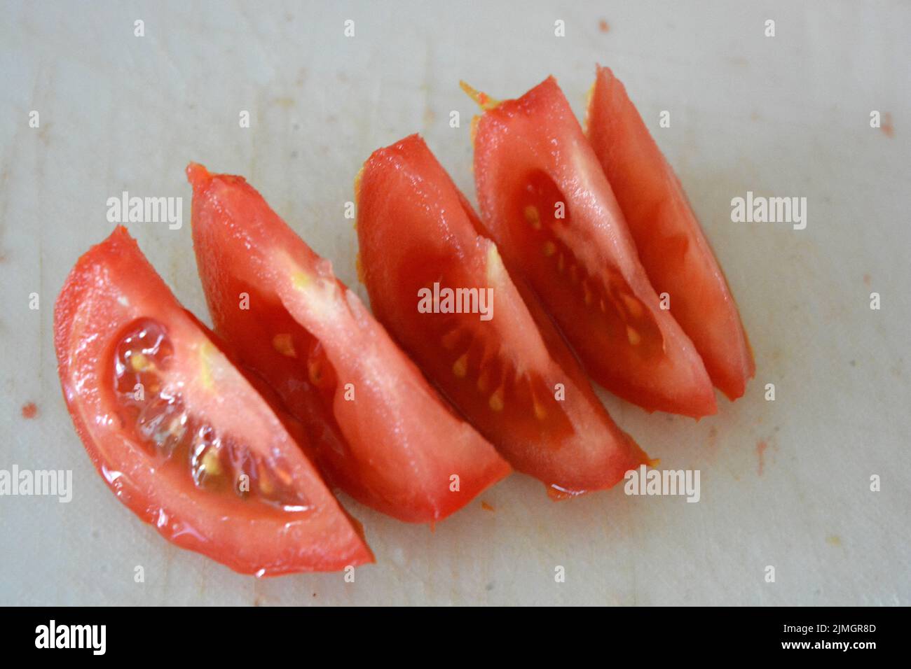 Healthy food, vegetables, large red tomatoes cut into slices or covered ...