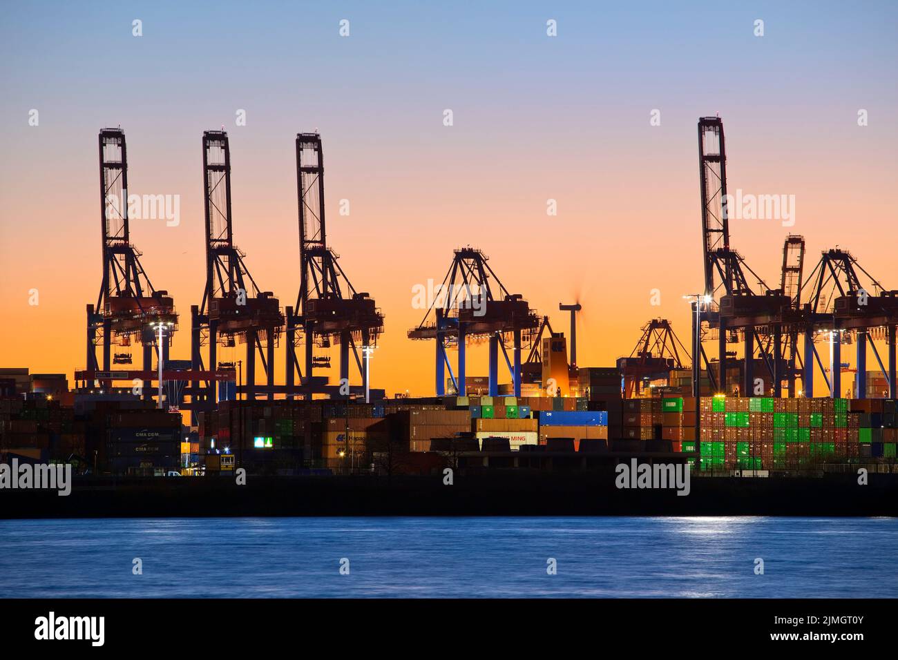 Loading cranes at the Burchardkai container terminal at sunset, Port of ...