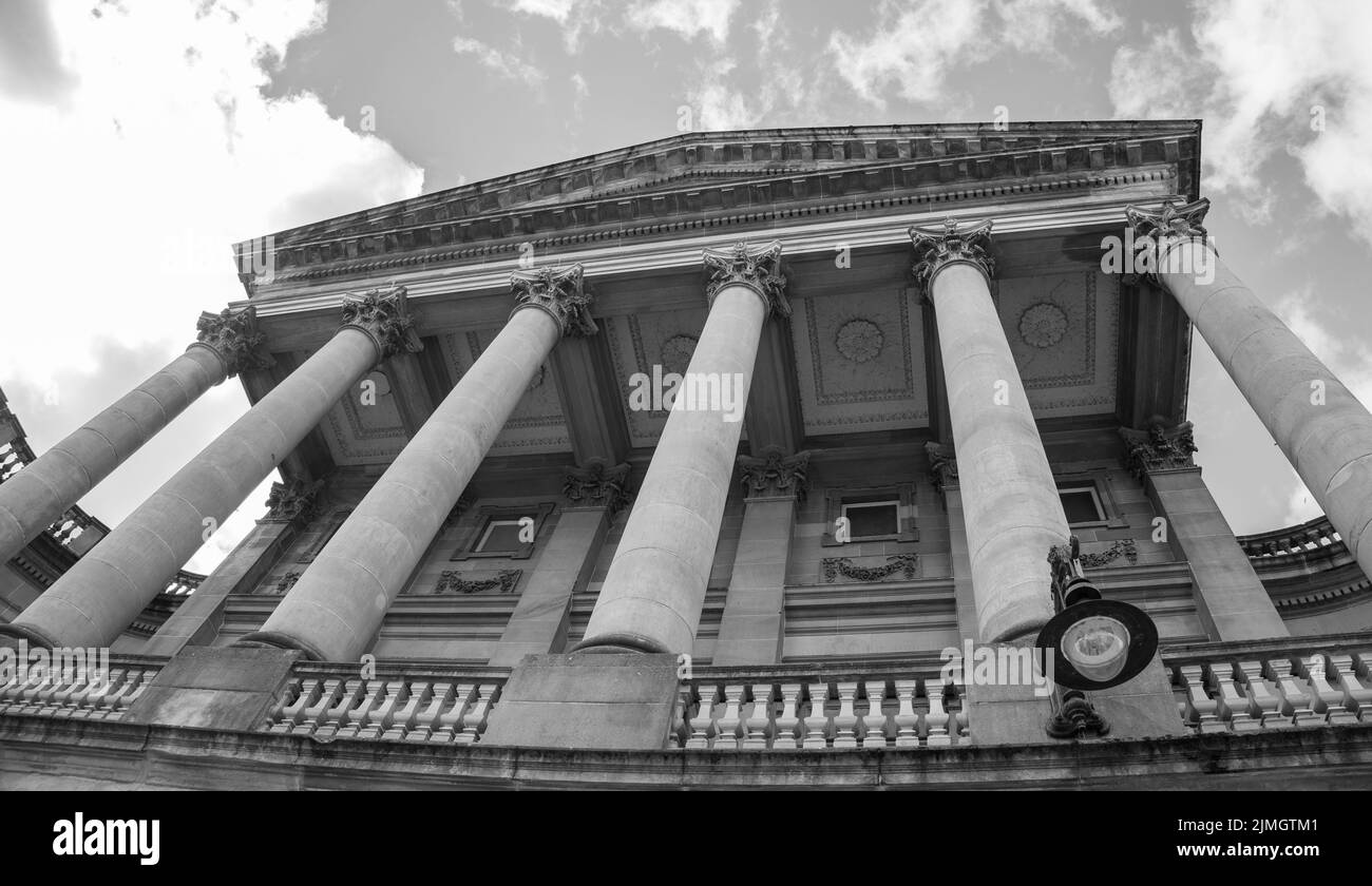 A low angle shot of a building with columns in Scotland in grayscale ...