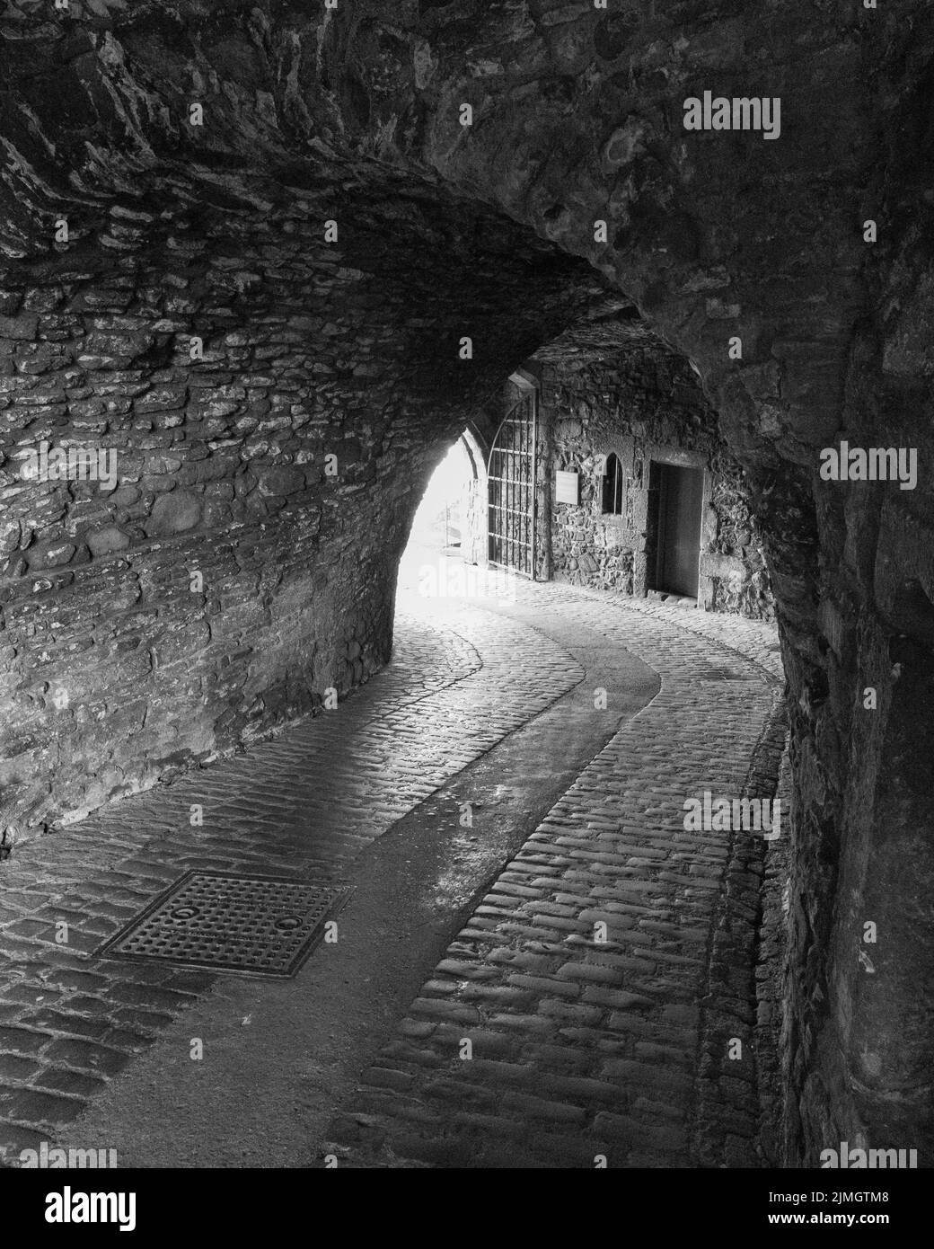 A narrow tunnel-like walkway in Scotland leading to a street in ...