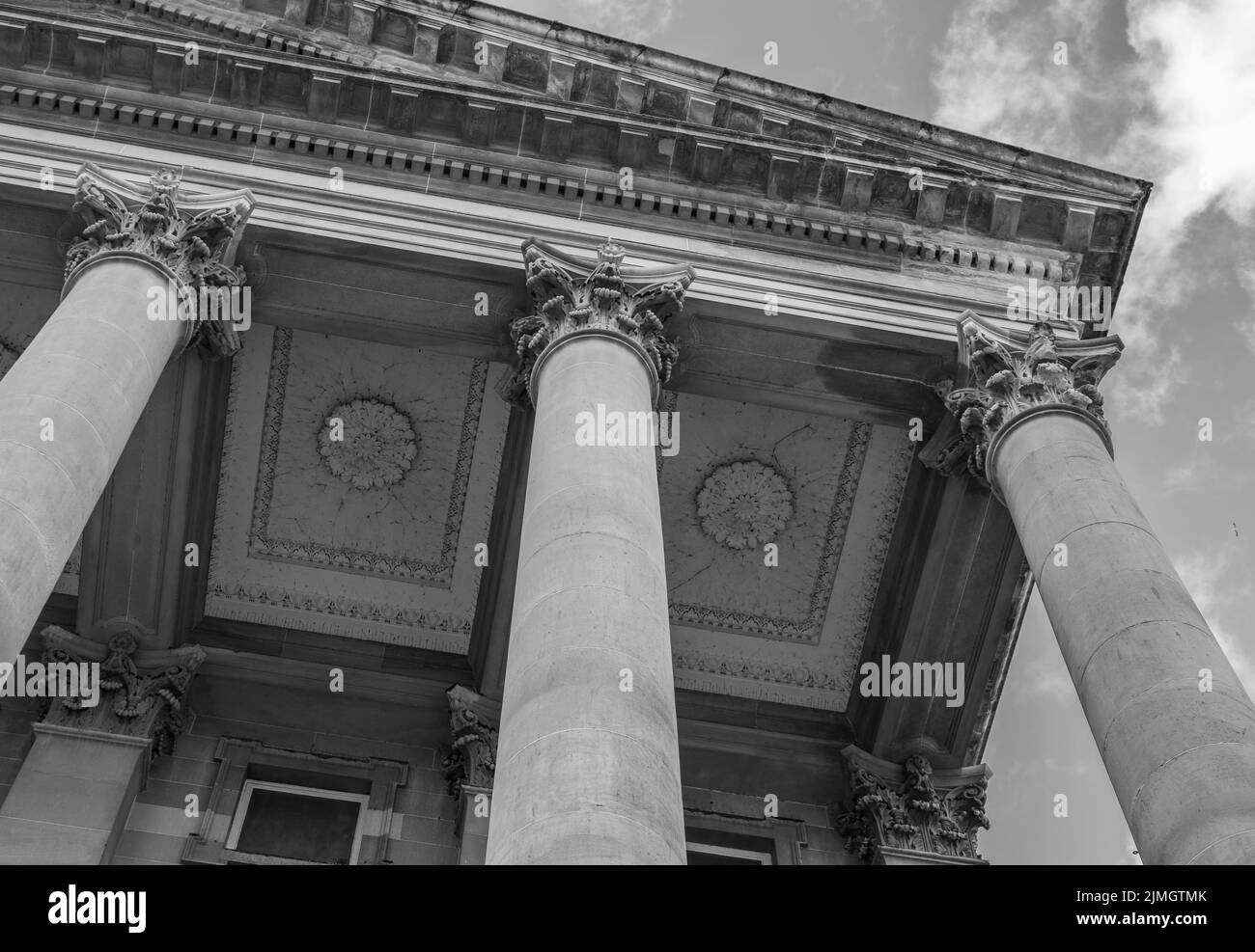 A low angle shot of an old Greek-style building with columns in ...