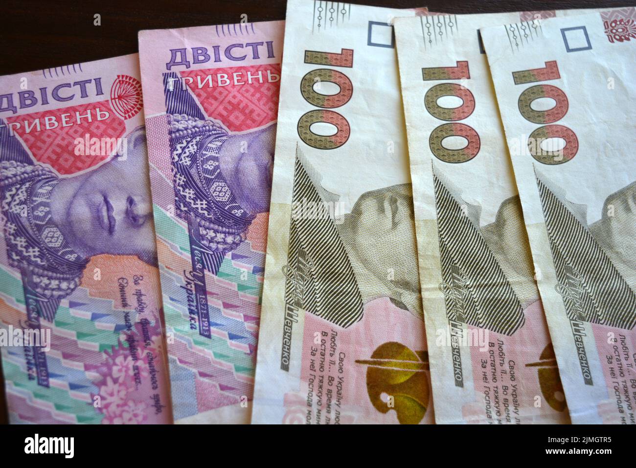 Bright, freshly printed money, large banknotes of 100 and 200 Ukrainian ...