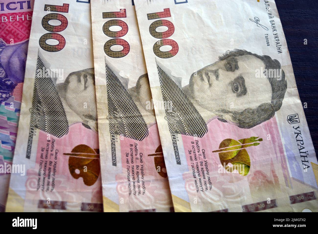 Bright, freshly printed money, large banknotes of 100 and 200 Ukrainian ...
