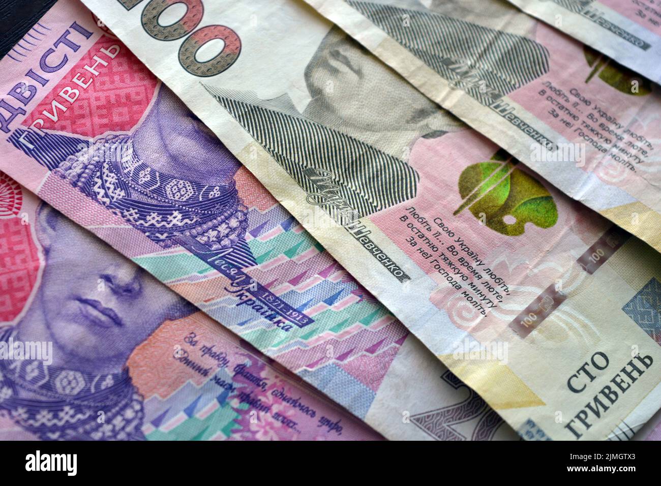 Bright, freshly printed money, large banknotes of 100 and 200 Ukrainian ...