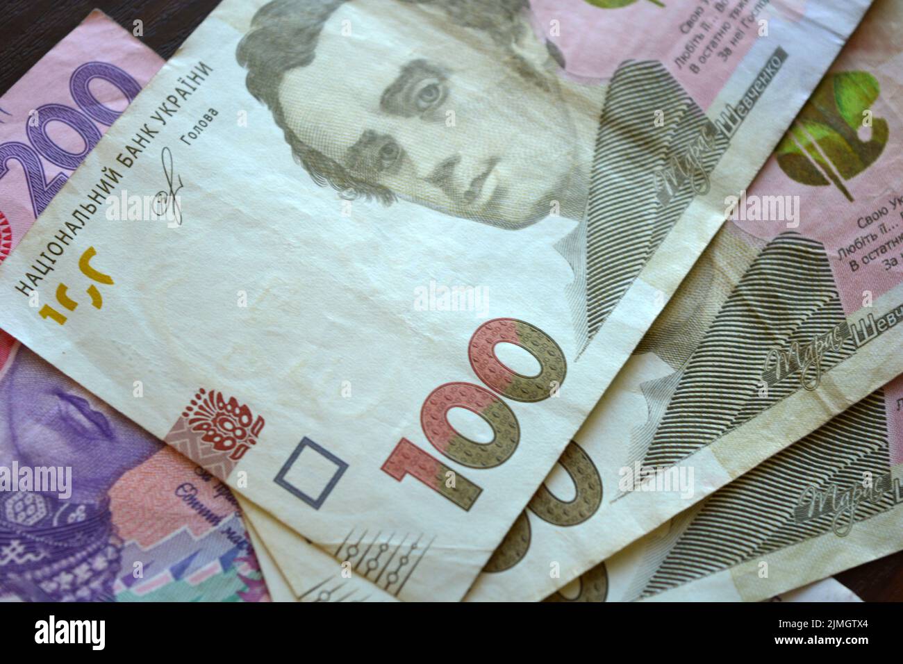 Bright, freshly printed money, large banknotes of 100 and 200 Ukrainian ...