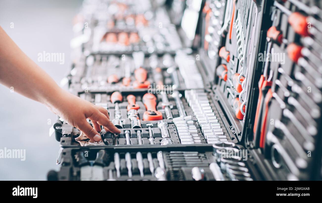 tool store showcase worker choosing instruments Stock Photo - Alamy