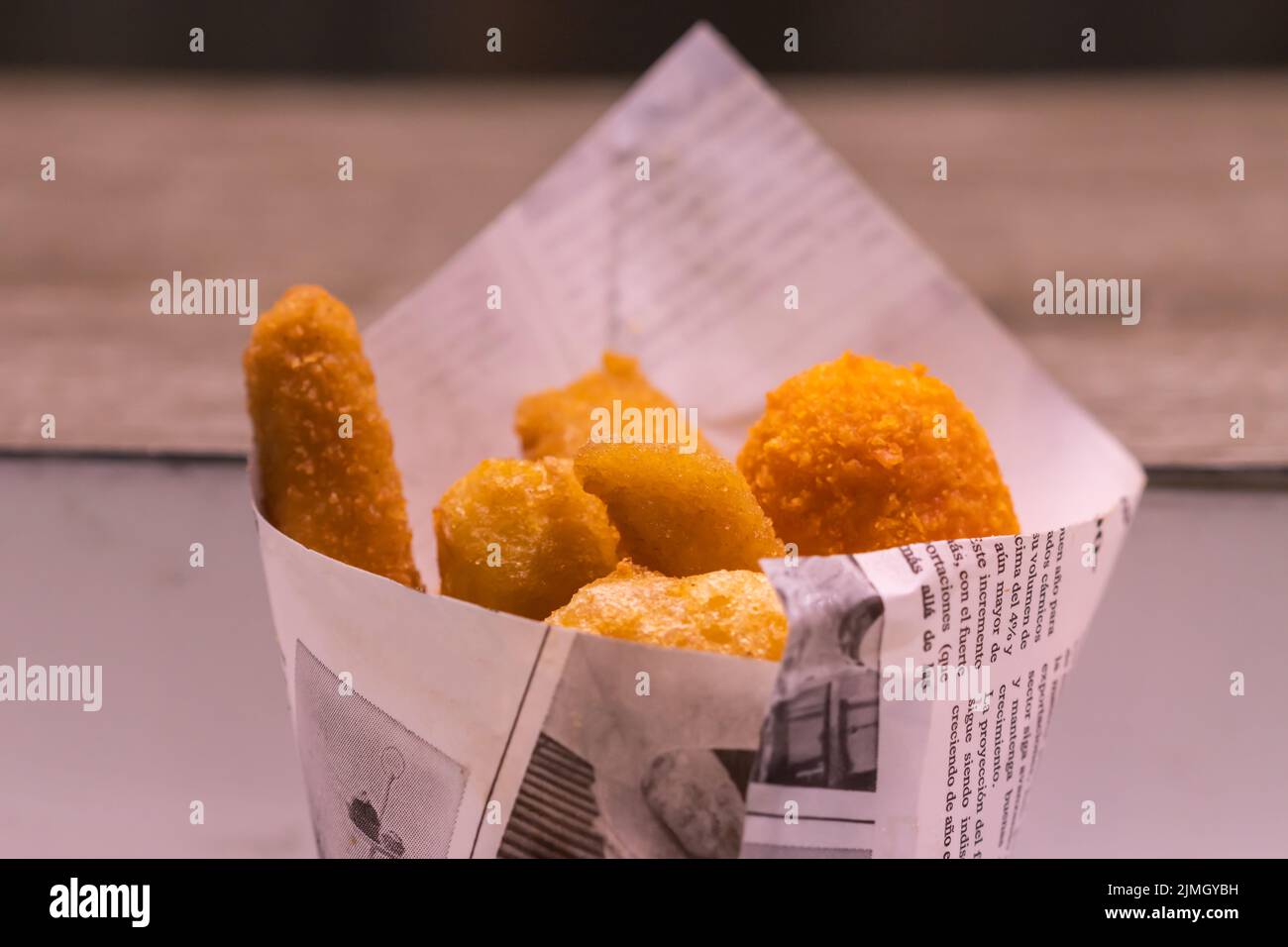 Fish, squid and cuttlefish fried and breaded in a paper container in a ...