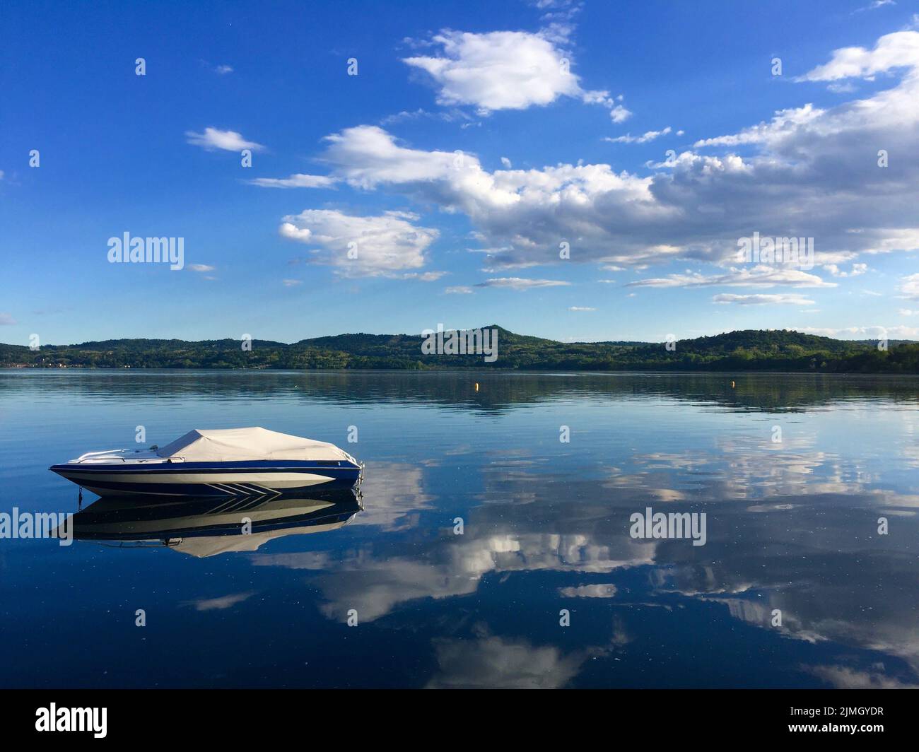 A boat anchored in the lake of Viverone in Sicily Stock Photo - Alamy