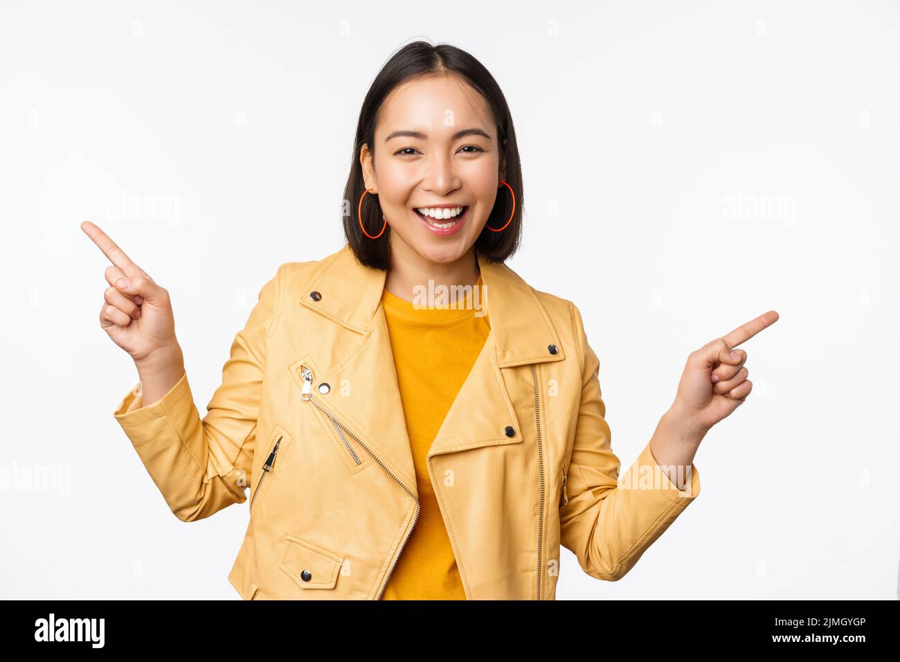 Happy beautiful asian girl pointing fingers left and right, showing ...