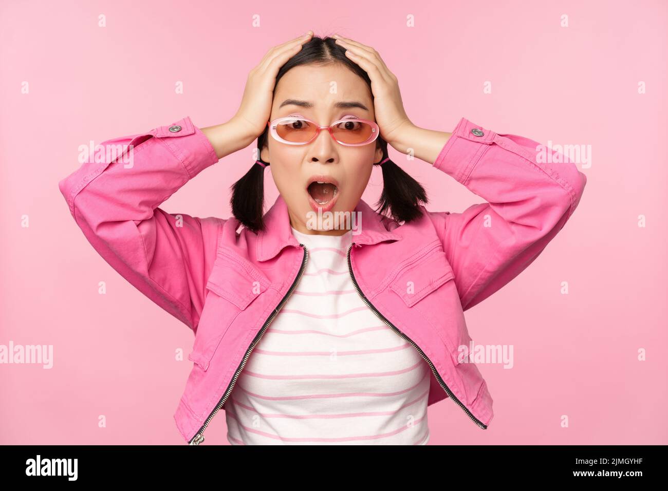 Portrait of troubled asian woman, korean girl holds hands on head and ...