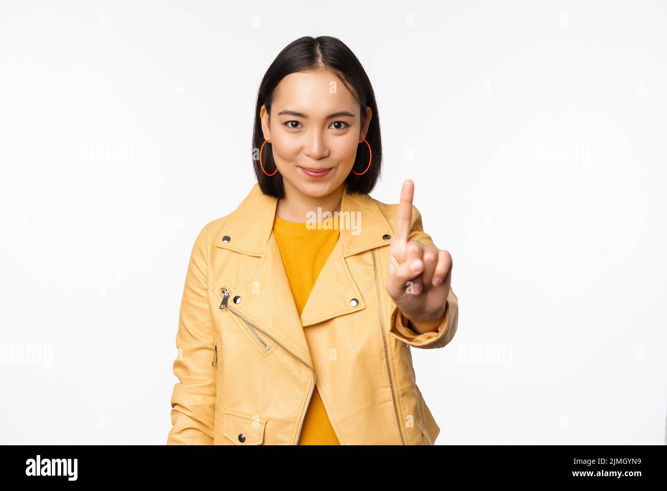 Rule number one. Confident smiling asian woman showing index finger ...