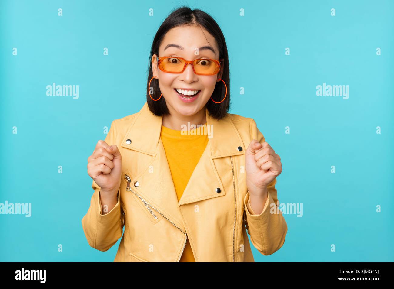 Image of enthusiastic young asian woman celebrating, triumphing ...