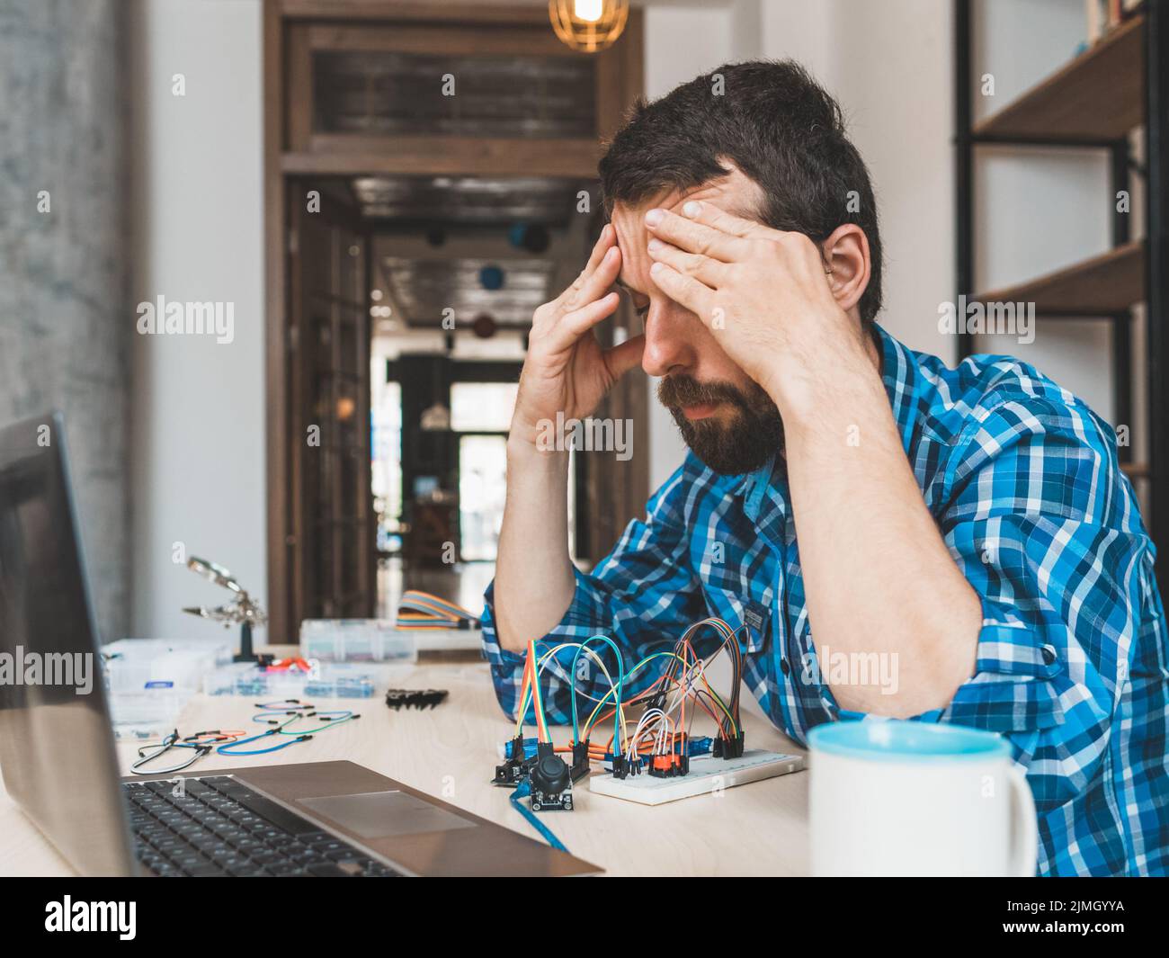 desperate stressed out engineer sitting laptop Stock Photo - Alamy