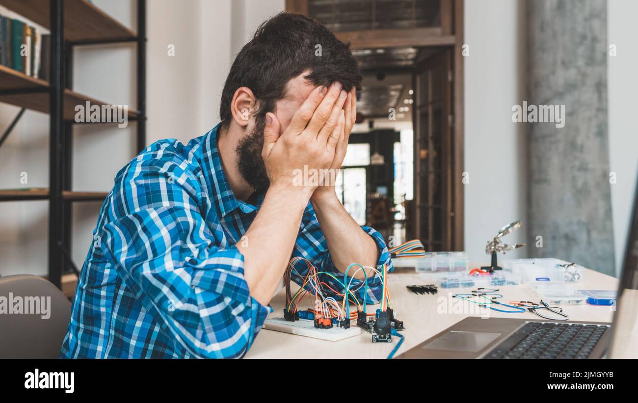 desperate stressed out engineer sitting laptop Stock Photo - Alamy