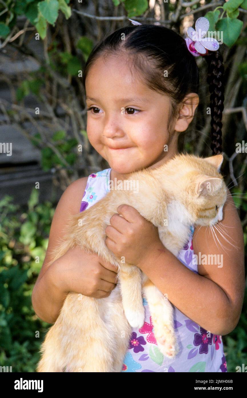 Young Native American girl holds a kitten on the Fort Hall Indian ...