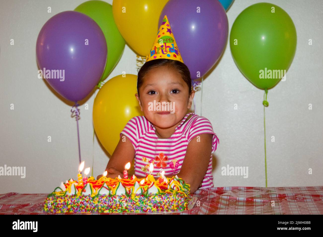 Native American girl celebrates her birthday with a decorated cake ...