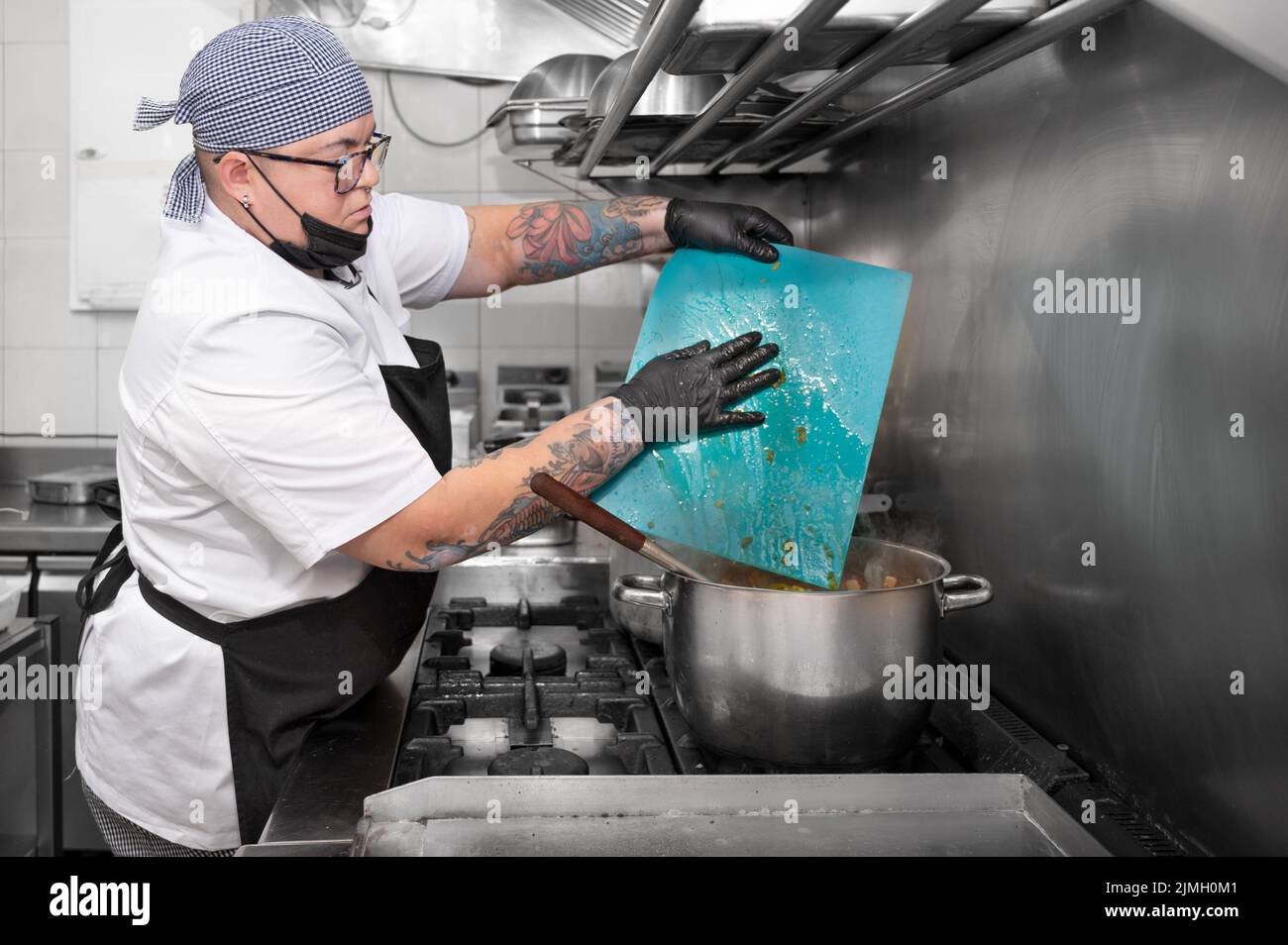 Side view of female chef working in commercial kitchen Stock Photo - Alamy