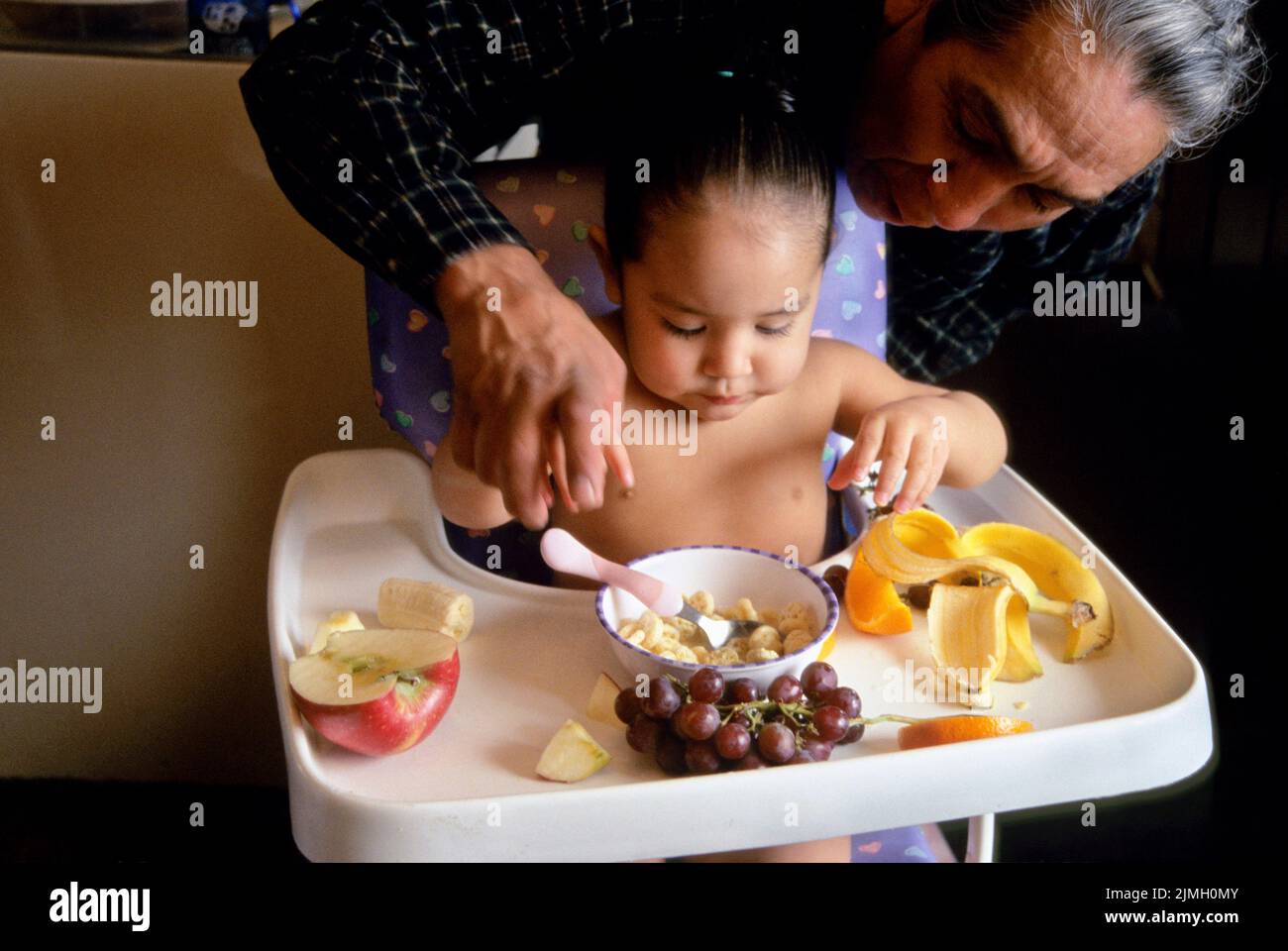 Native American family of a grandfather feeding his 1 year old ...