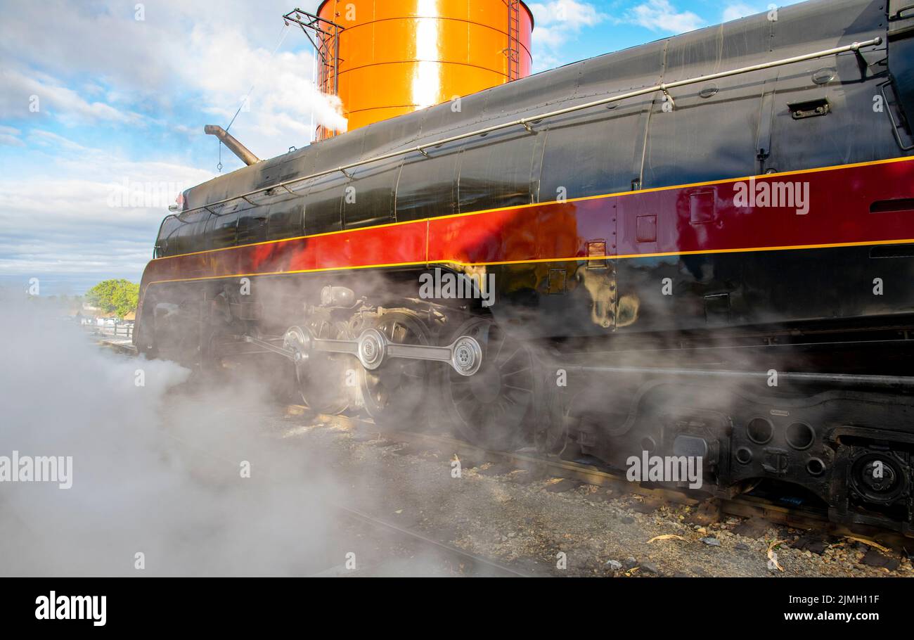 Close Up of a Big Restored Steam Engine Passing By Blowing Lots of ...