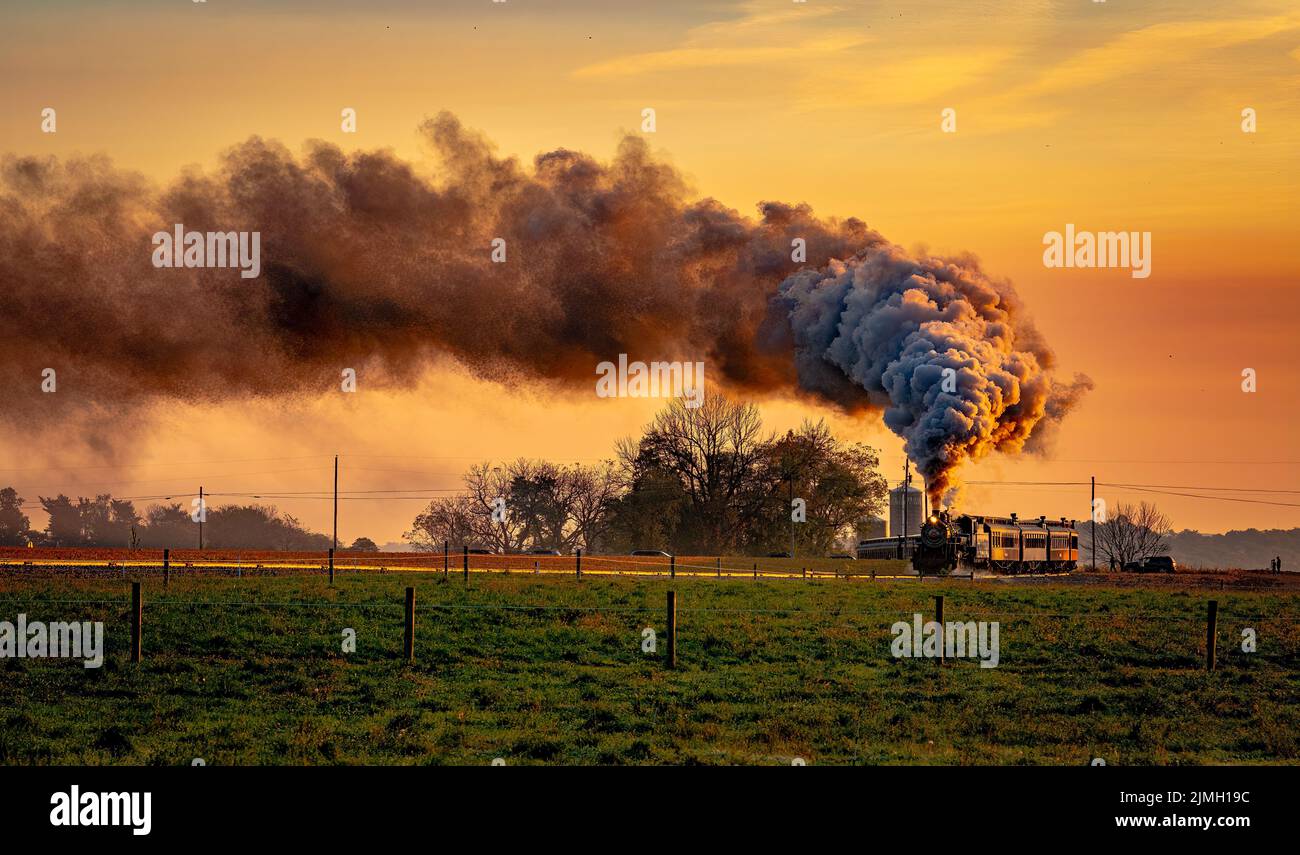 View of an Antique Steam Passenger Train Approaching at Sunrise With a ...