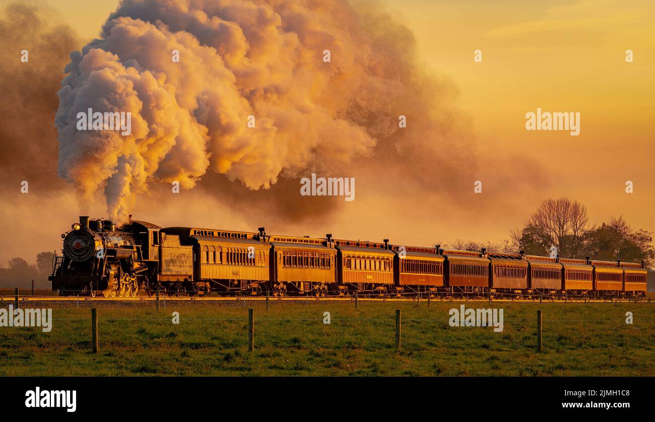 View of an Antique Steam Passenger Train Approaching at Sunrise With a ...