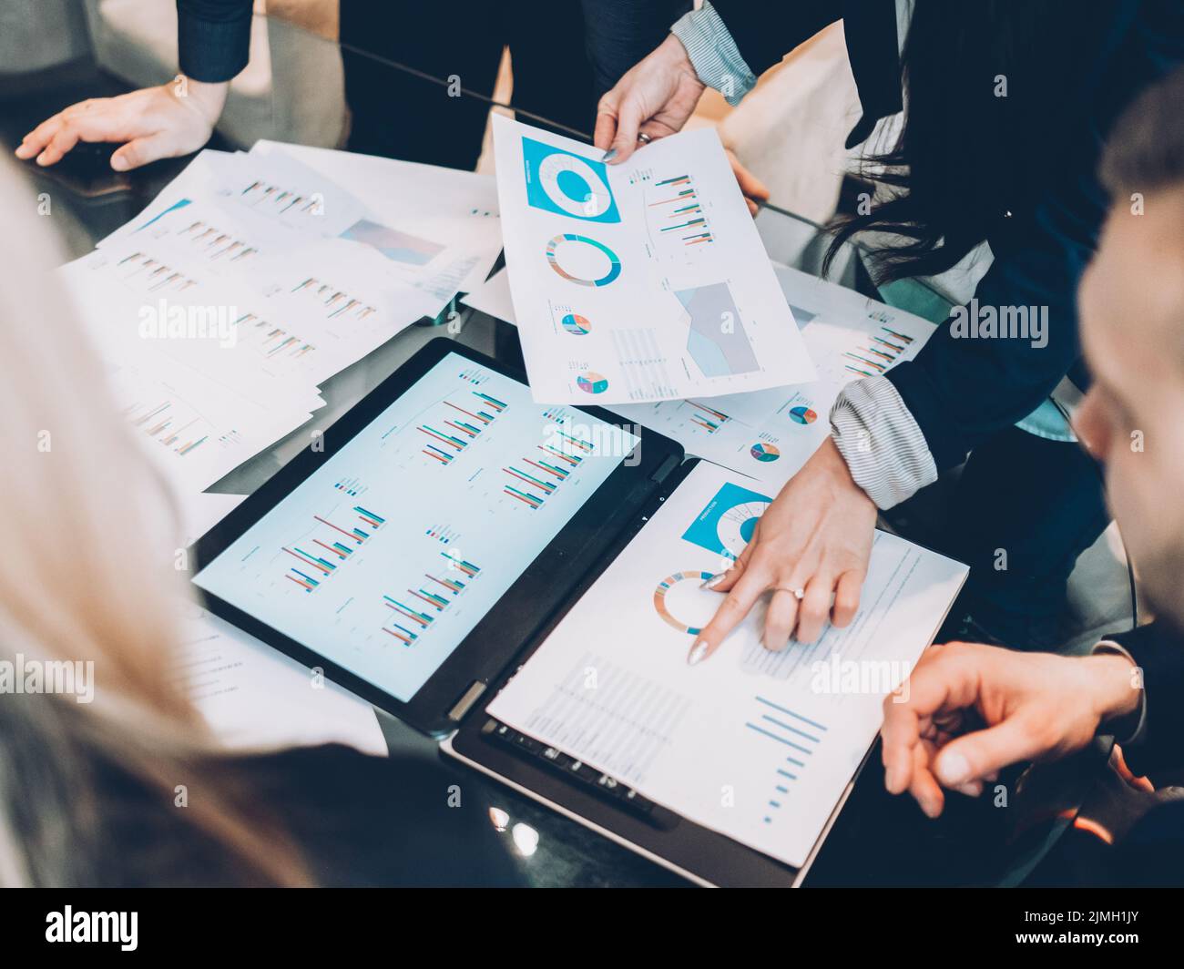 teamwork brainstorming business partners graphs Stock Photo - Alamy