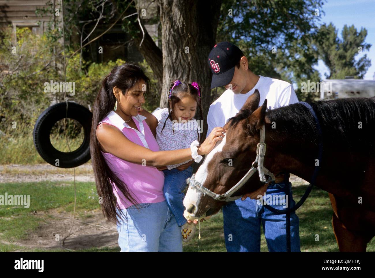 Native American family of mother and father show their 4 year old ...