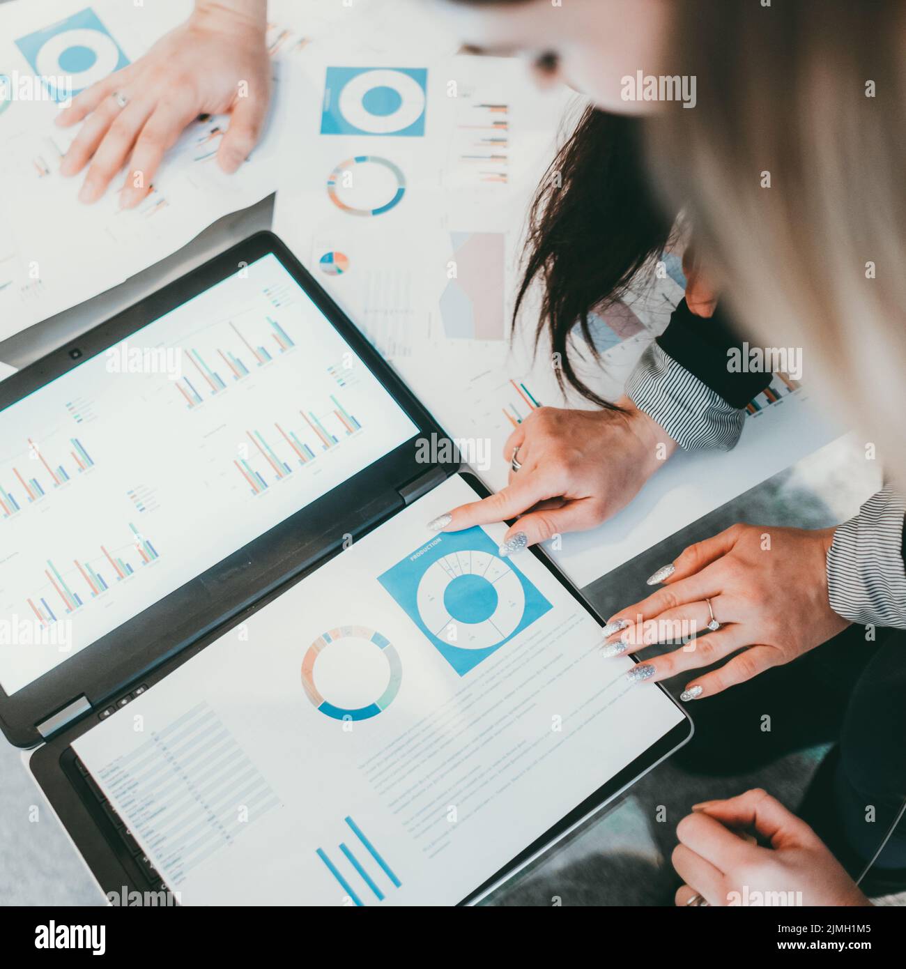 teamwork brainstorming business partners graphs Stock Photo - Alamy