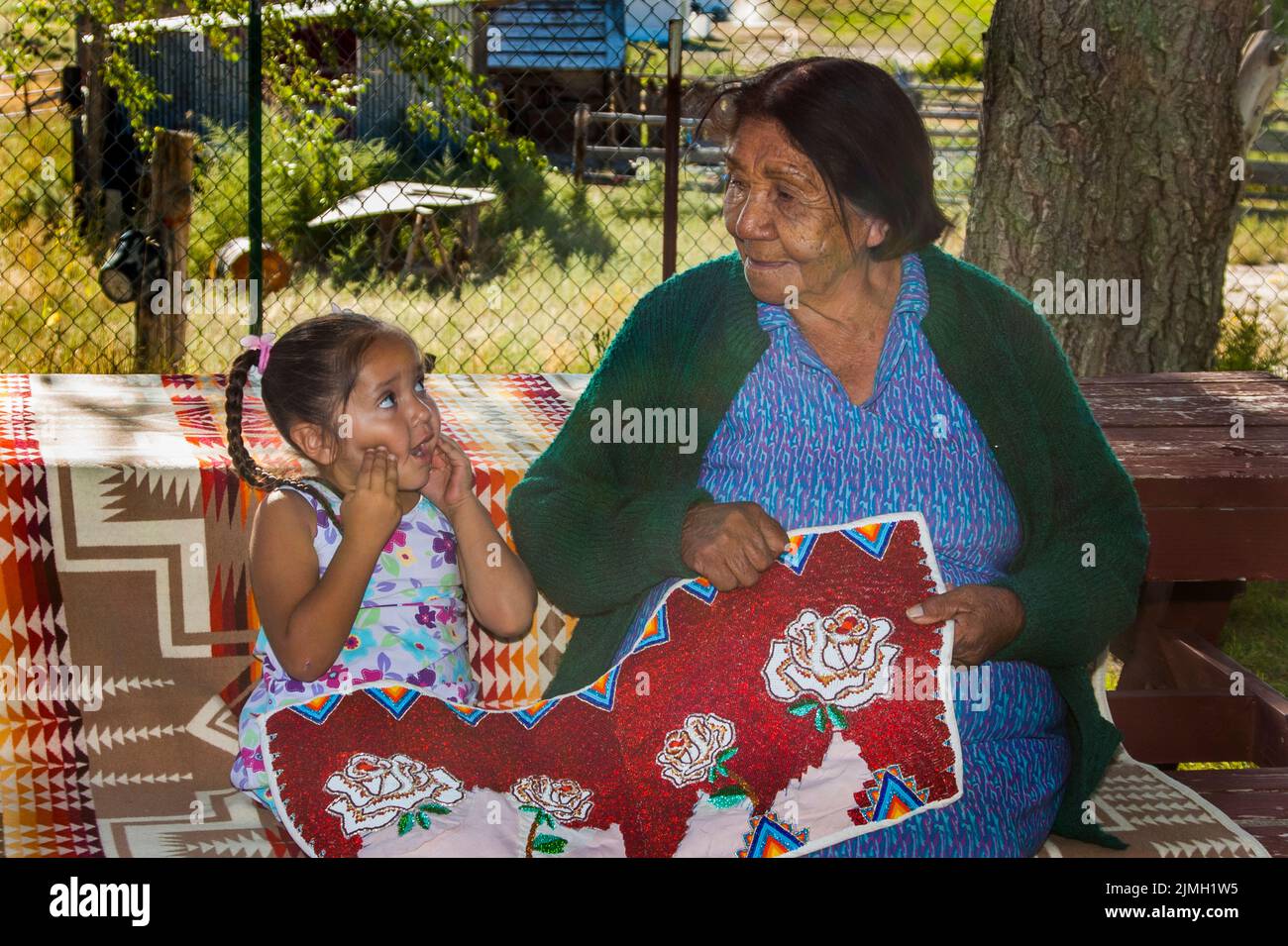 Native American grandmother shows her traditional beadwork to ...