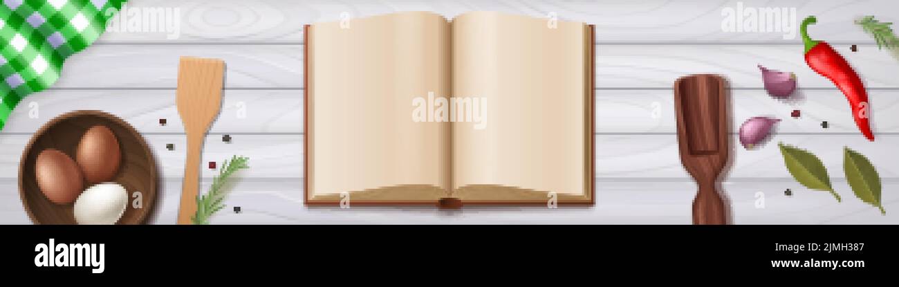 Top view of kitchen table with open recipe book, ingredients and ...