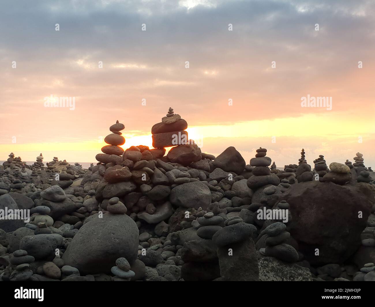 Stone tower on the sea beach. Rock piles at sunset in Tenerife Stock ...
