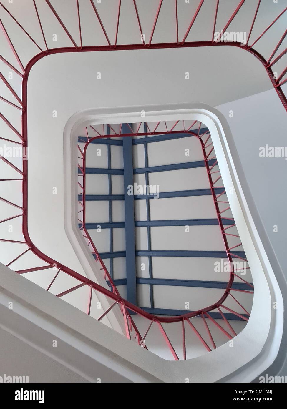 Winding staircase, stairwell red blue colored Stock Photo - Alamy