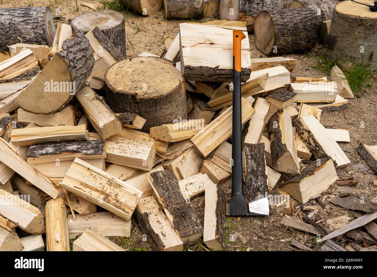 Professional axe and chopped firewood in the yard of the house Stock ...
