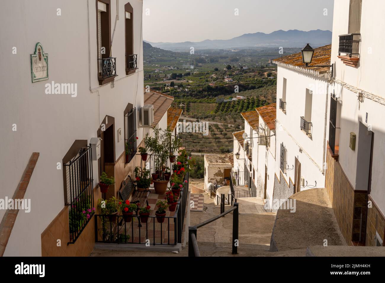 Narrow hillside street in the picturesque Andalusian village of Alora ...