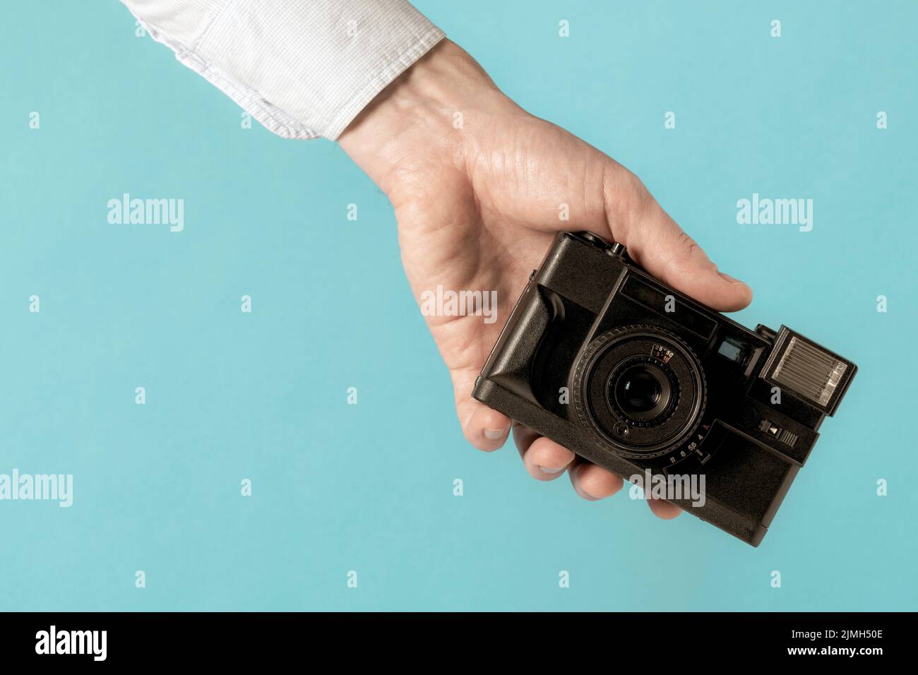 Hand holding old film photo camera Stock Photo - Alamy