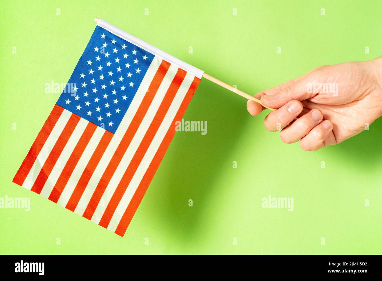 Hand holding small american flag Stock Photo - Alamy