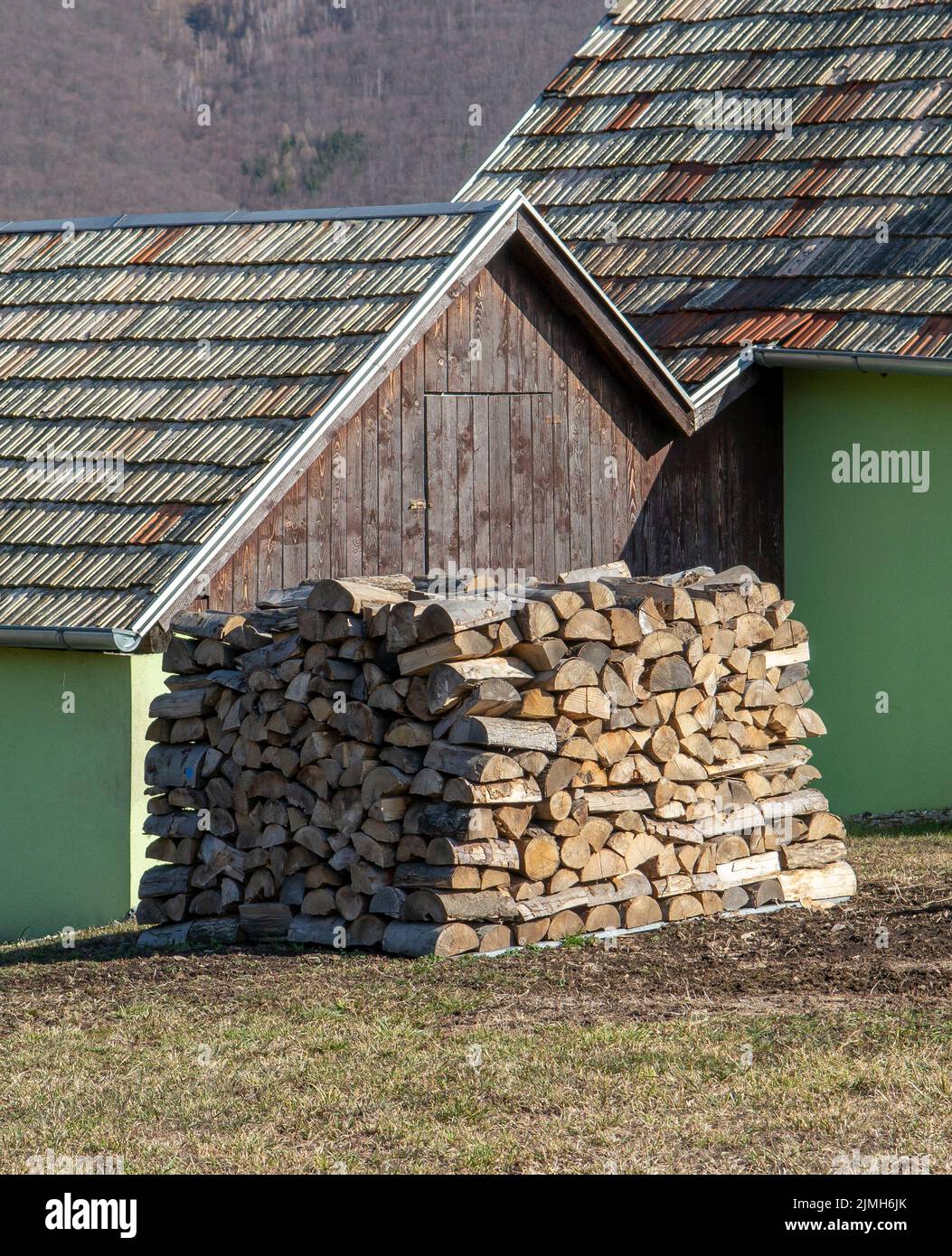 Pile of firewood in the courtyard. Heap of the wooden logs stacked ...