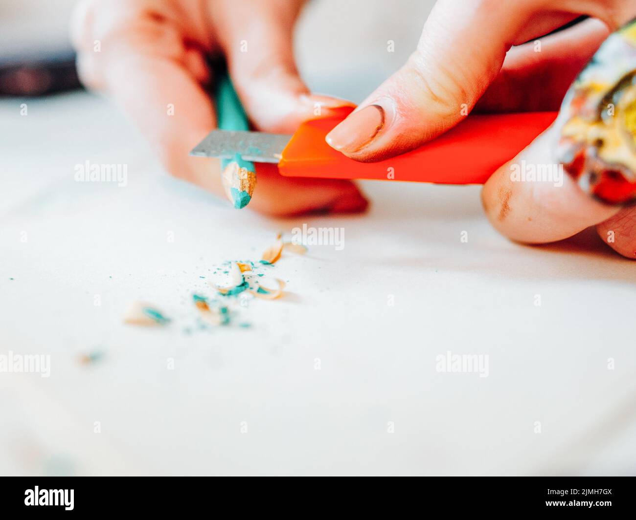 fine art class painter sharpening colored pencil Stock Photo - Alamy
