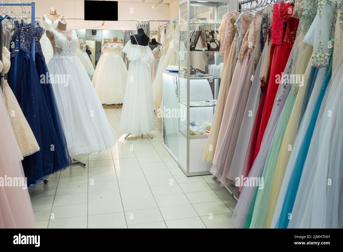 Many different evening and wedding dresses on a hanger in a general ...