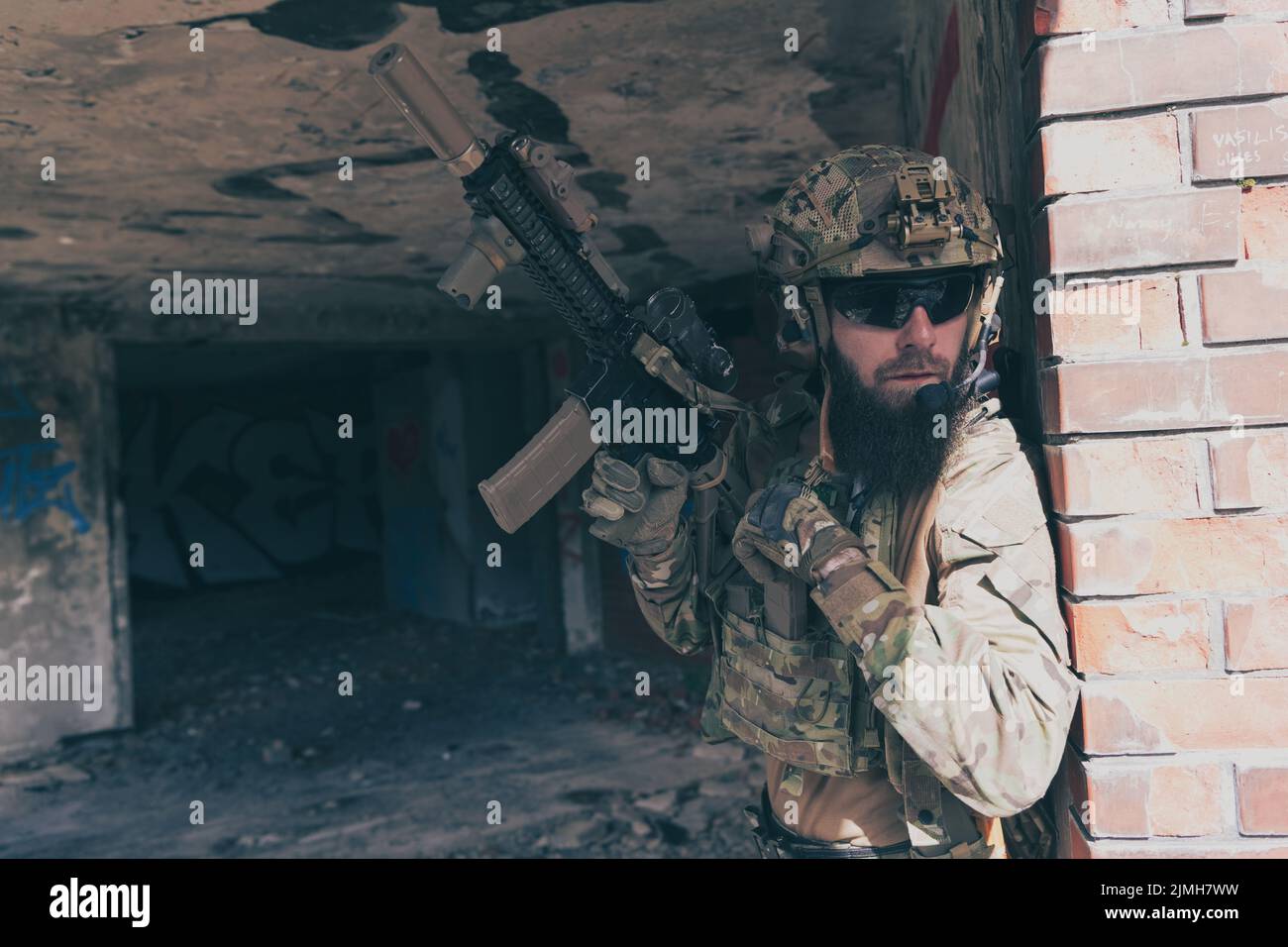 A bearded soldier in special forces uniform in dangerous military ...