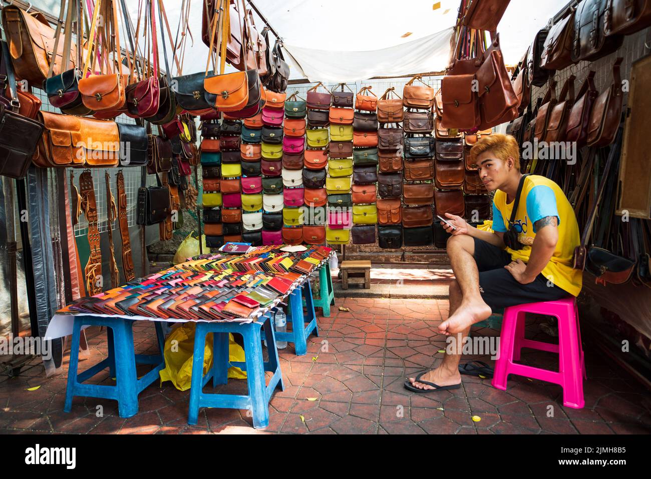 Street shops in Bangkok city. A shop selling colorful bags and a ...