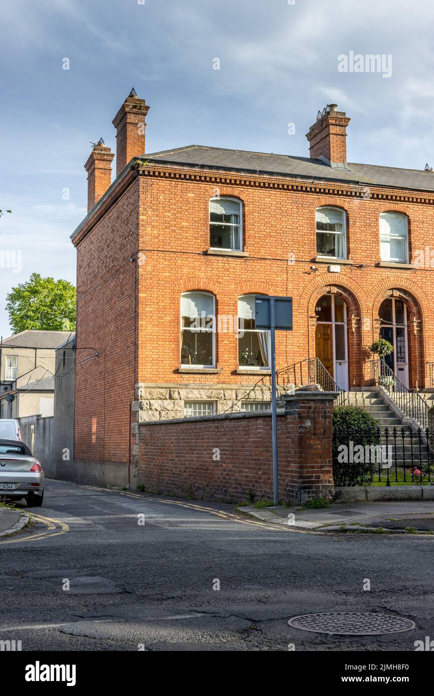 A vertical shot of a brick building in Dublin Ireland in a neighborhood ...