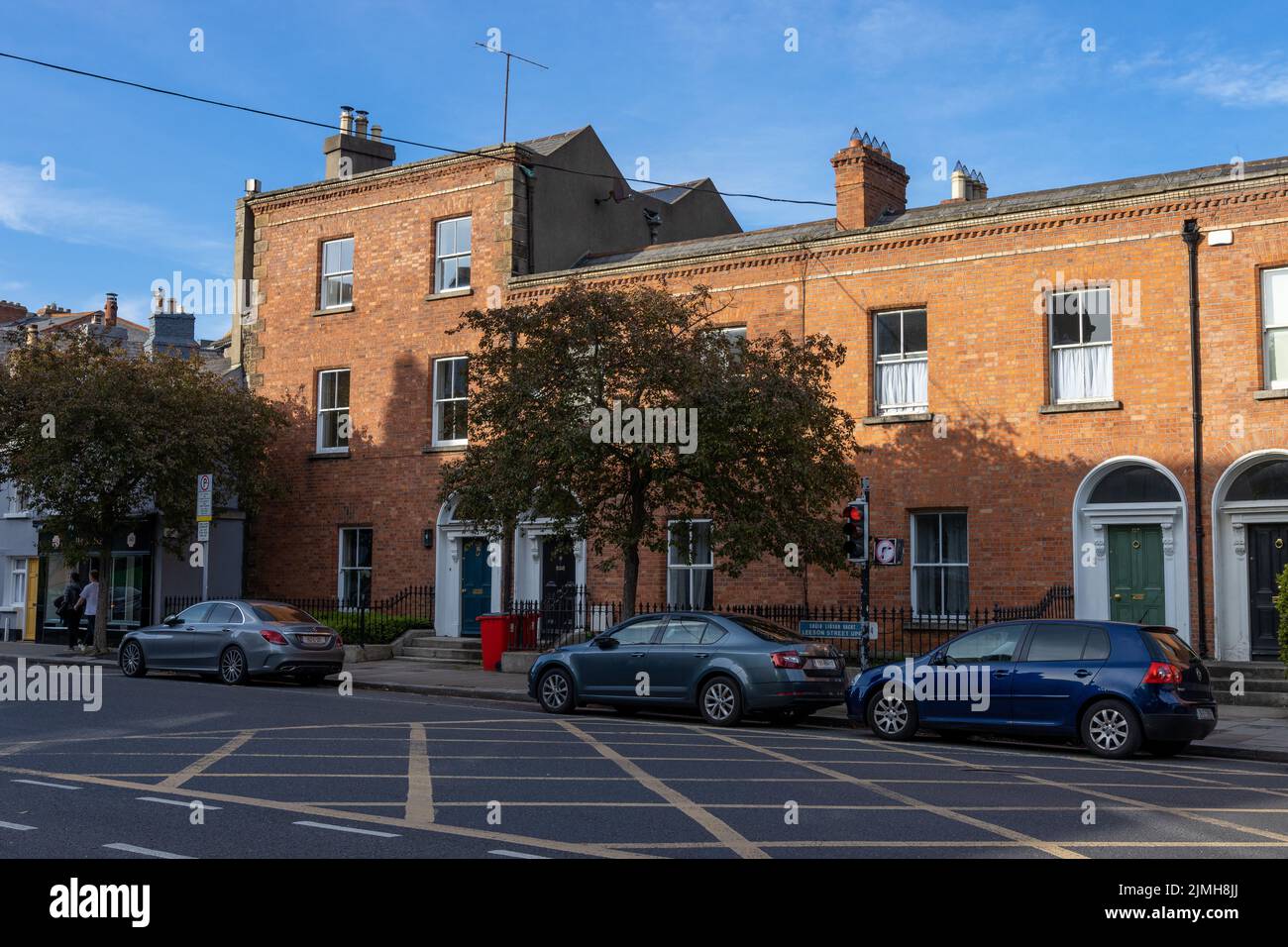 A brick building in Dublin Ireland in a neighborhood with parked cars ...