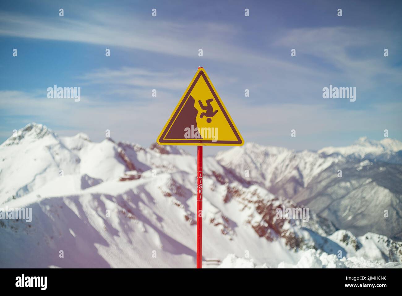 Sign on background of mountains. Sign warning of danger of falling ...