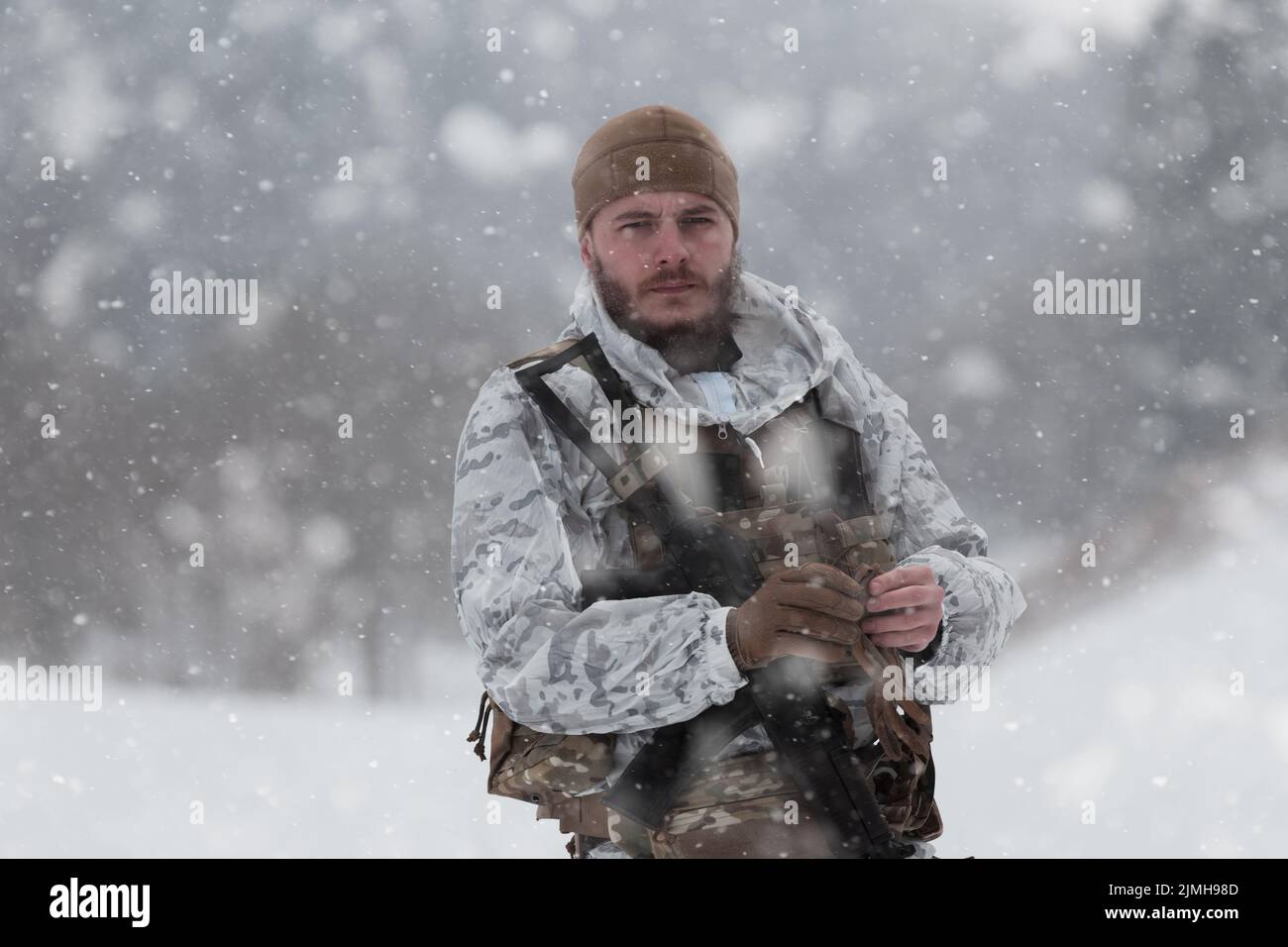 Soldier in winter camouflaged uniform in Modern warfare army on a snow ...