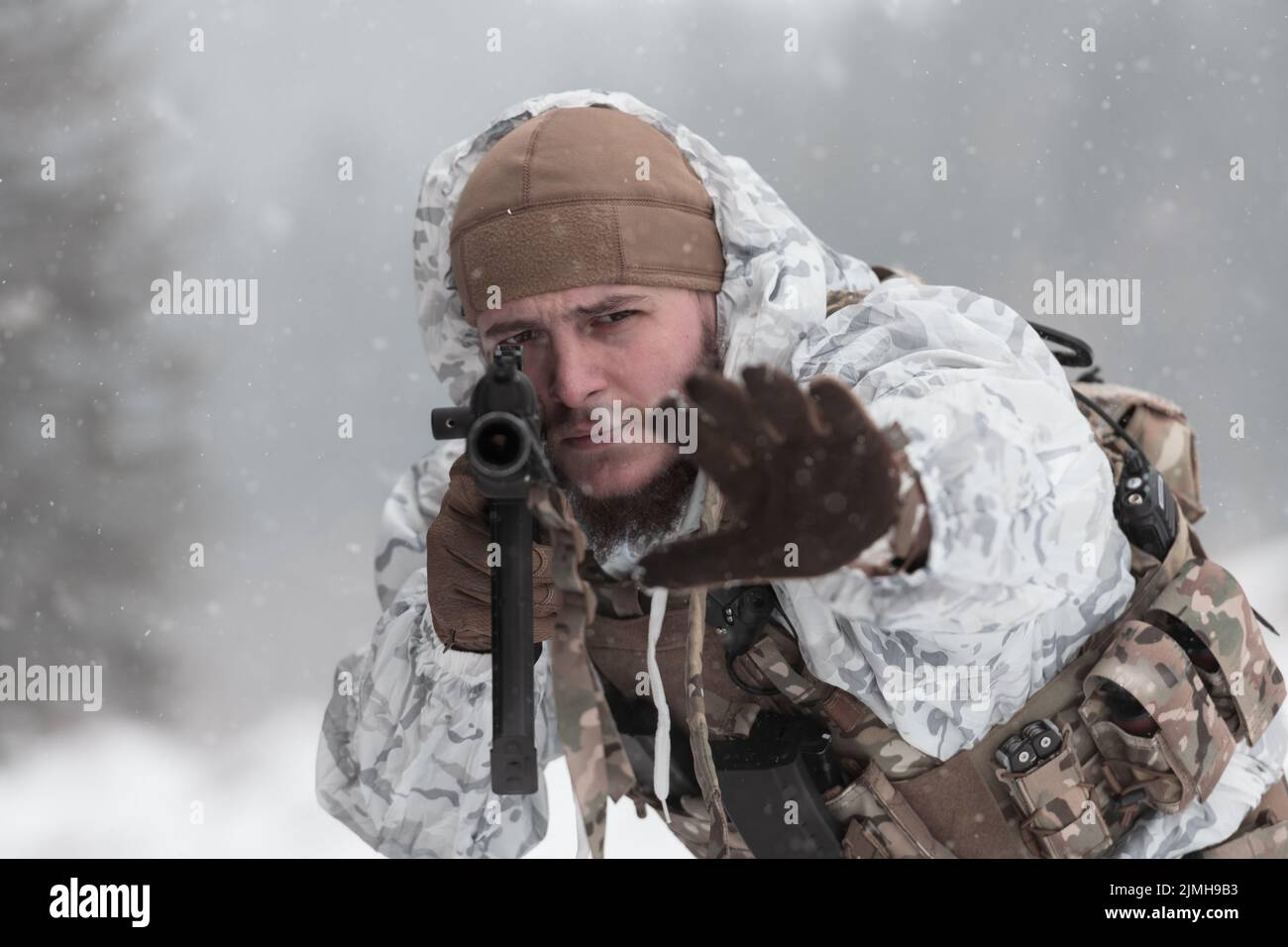 Soldier in winter camouflaged uniform in Modern warfare army on a snow ...