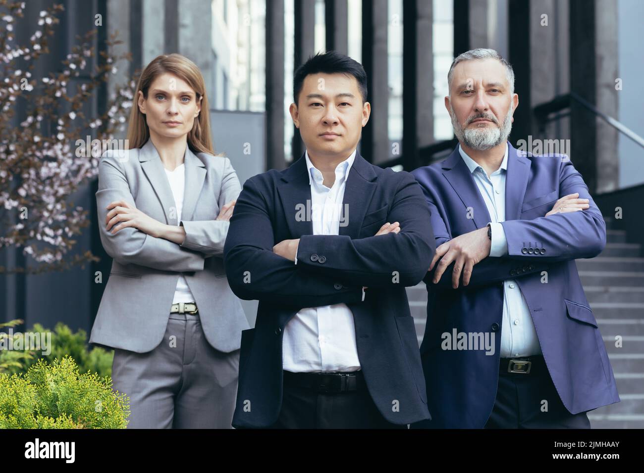 Asian boss with team, portrait of group of people with crossed arms ...