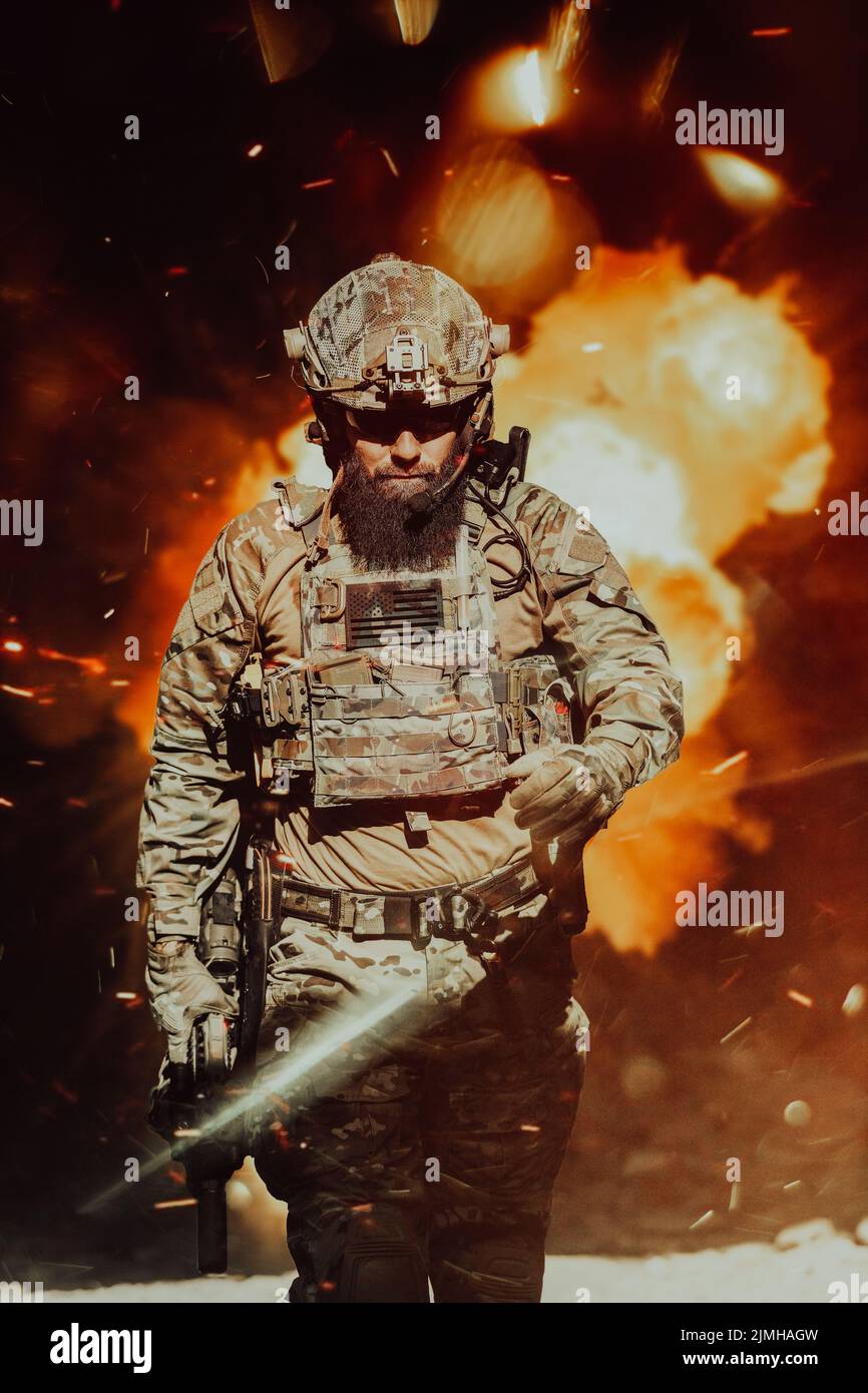 A bearded soldier in a special forces uniform walks through an ...